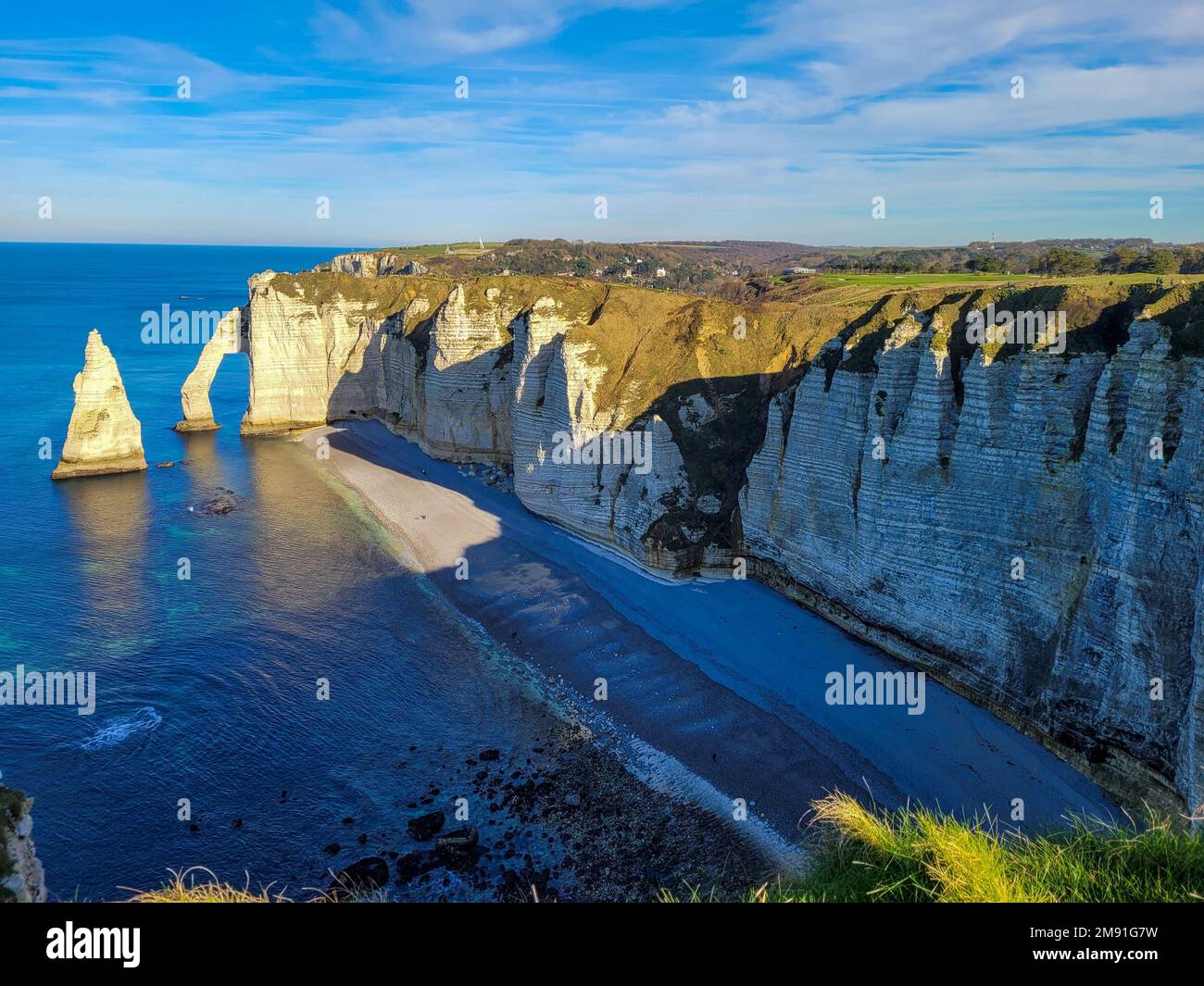 An aerial view of white cliffs overlooking the sea in Falaise d'Aval ...