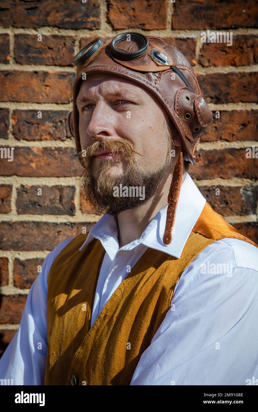 Portrait of an heroic looking man with a beard. He is wearing an old ...