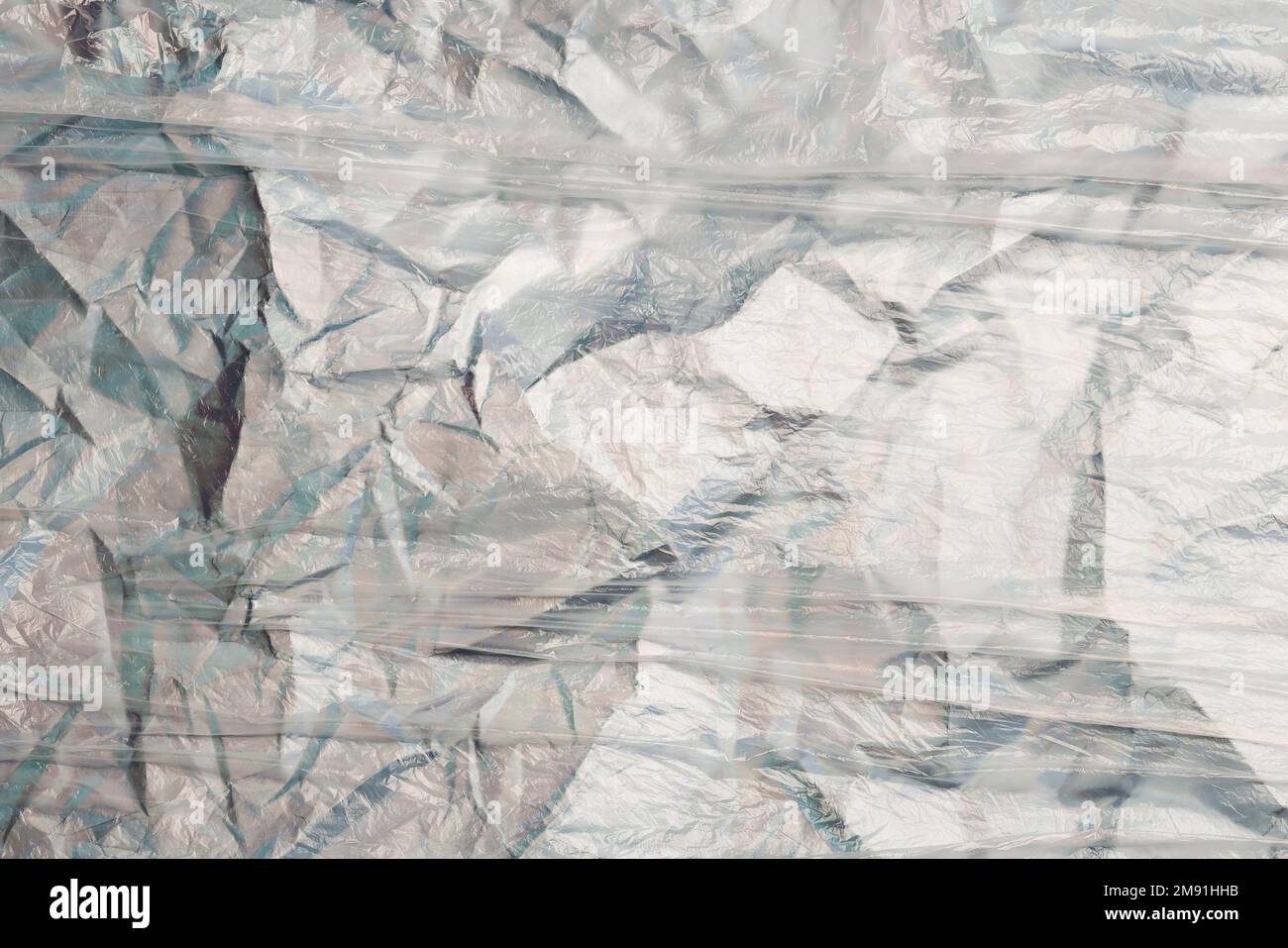 cellophane on metallic crumpled blue background. plastic textures ...