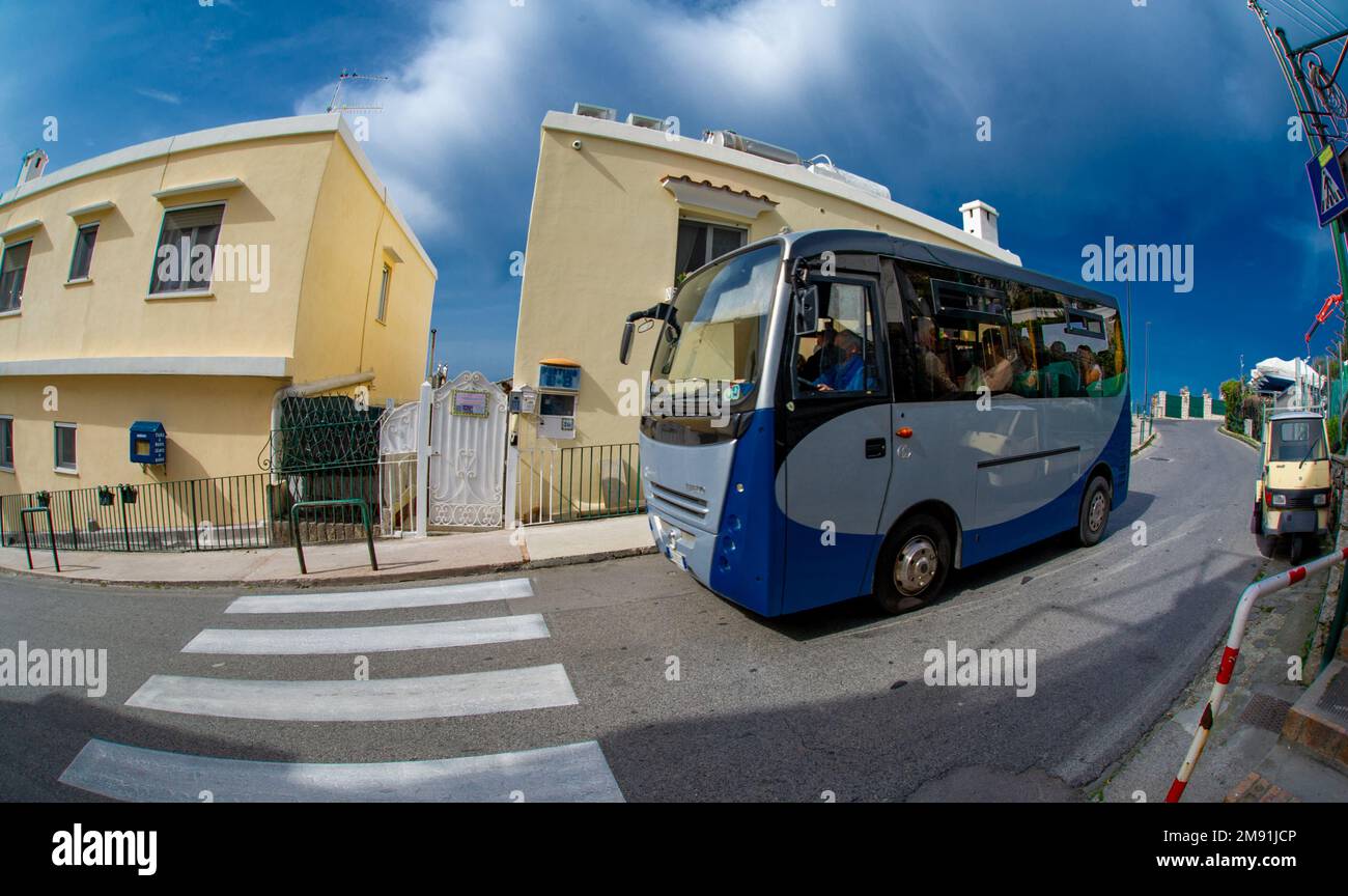 April 24 2022-Capri Italy - Small blue bus on the narrow, winding roads ...