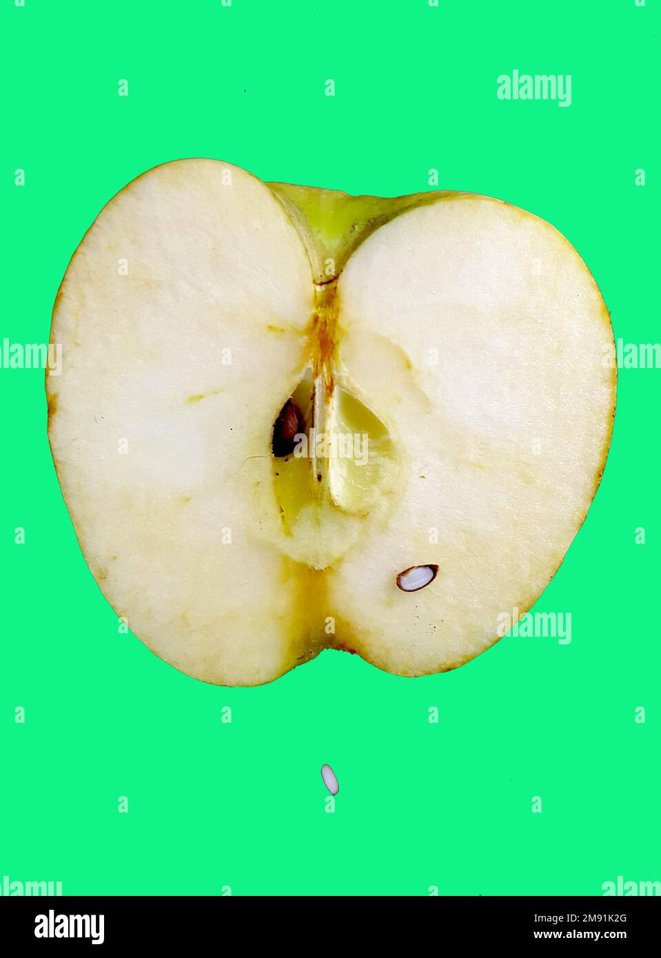 golden delicious apples isolated on green background Stock Photo - Alamy