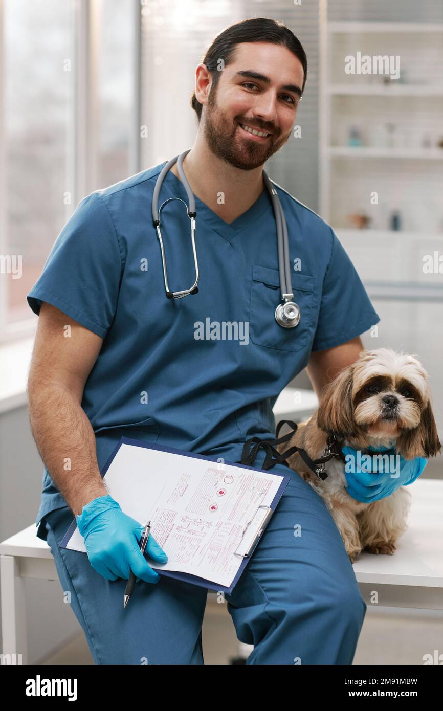 Happy young professional veterinary doctor with medical document in ...