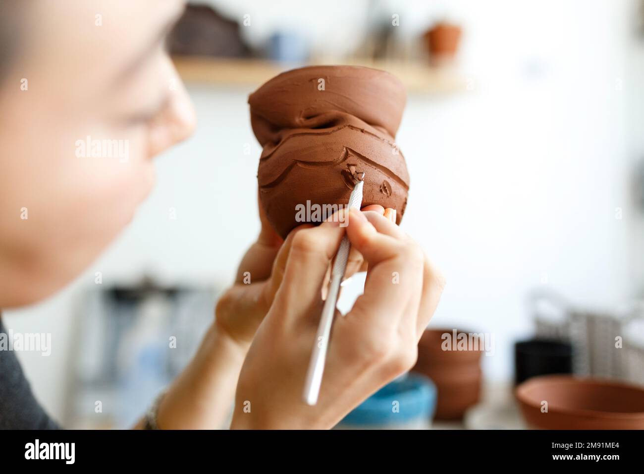 Female hands hold a bowl for casting clay products. Shaped method for ...