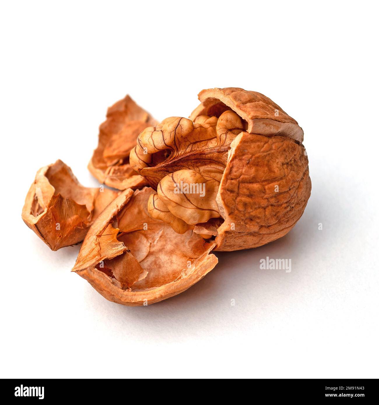 Cracked walnuts against white background Stock Photo - Alamy