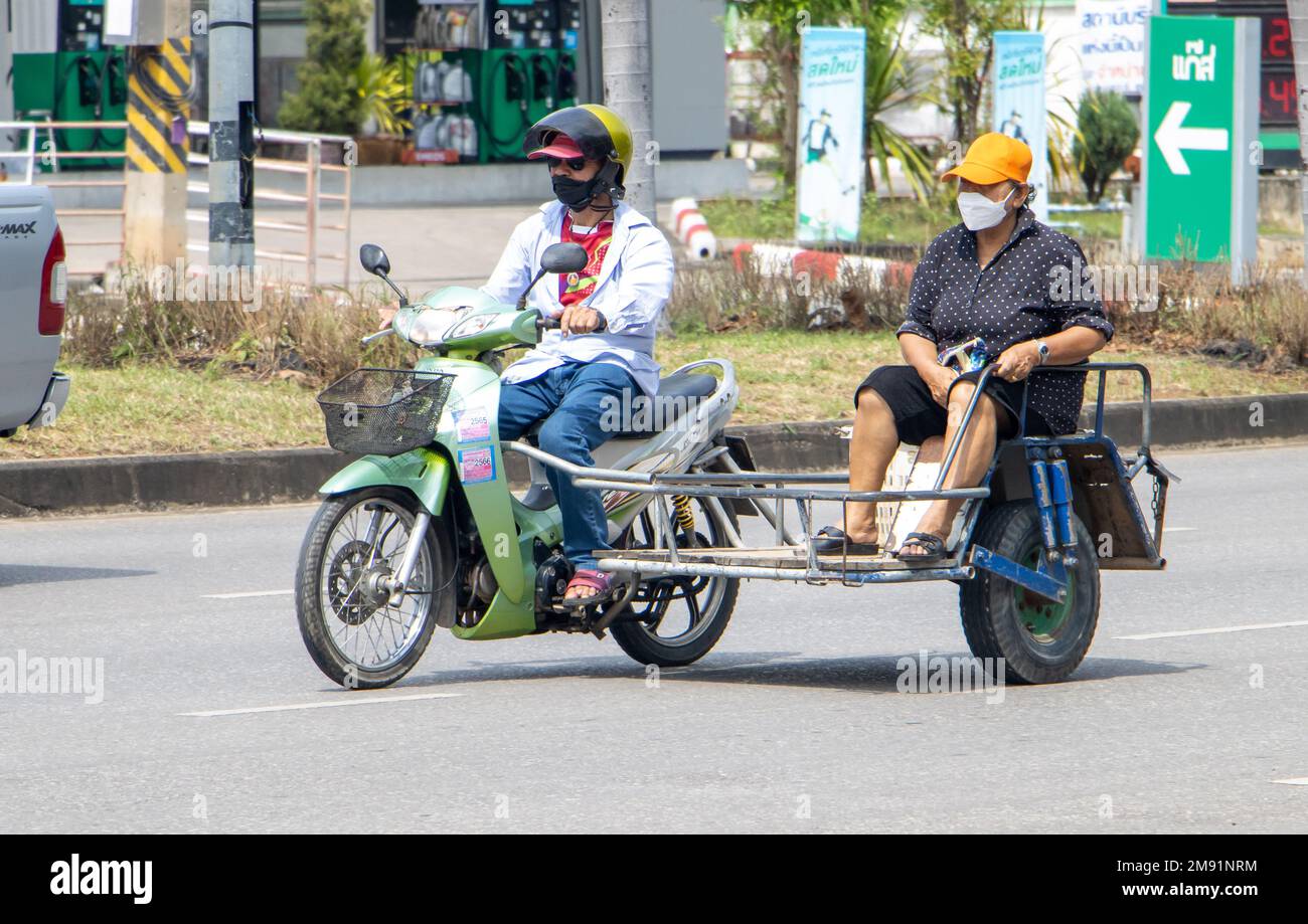 RATCHABURI, THAILAND, NOV 16 2022, A pair ride a motorcycle with a ...