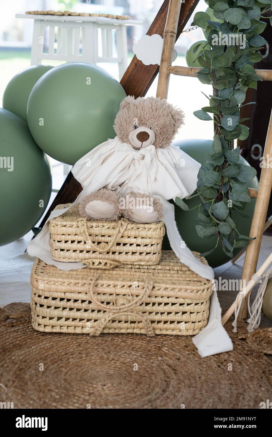 A decorated Green Balloons Garland Kit and teddy bear, vertical shot ...