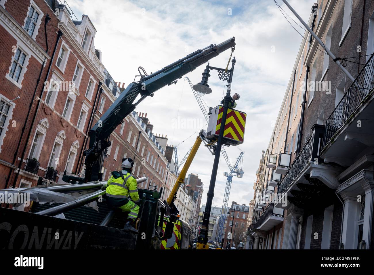 Street lighting technicians with the contractor, Conway, change street ...