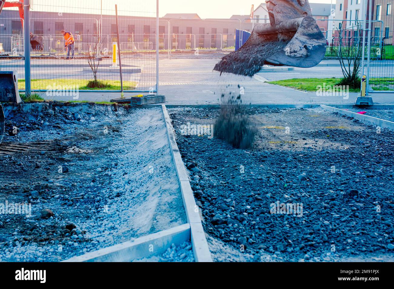 A new footpath is under construction as builders bring stone, levelling ...