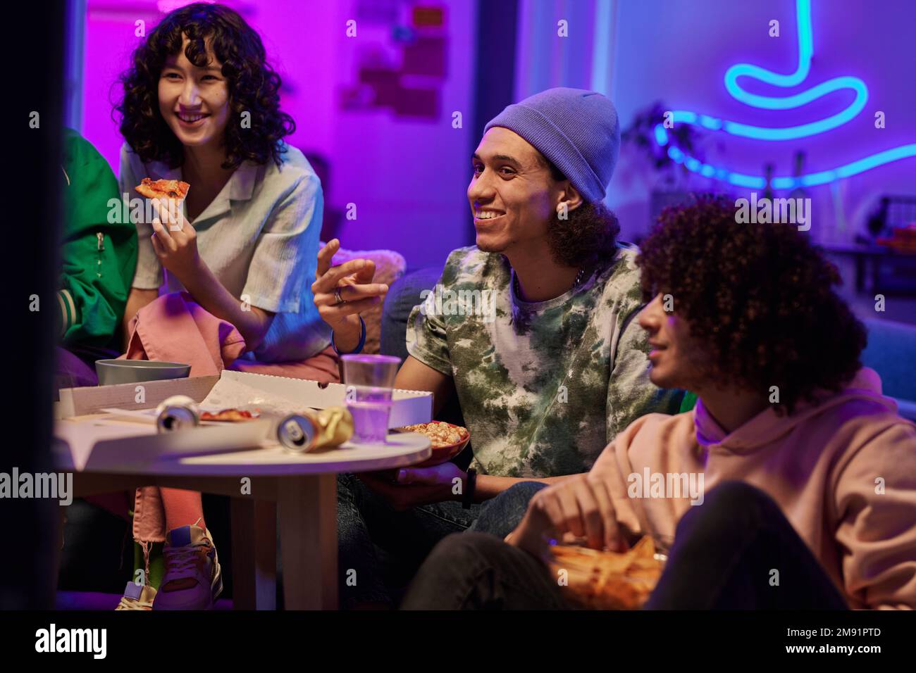 Group of multicultural adolescent guys and girls enjoying home party ...