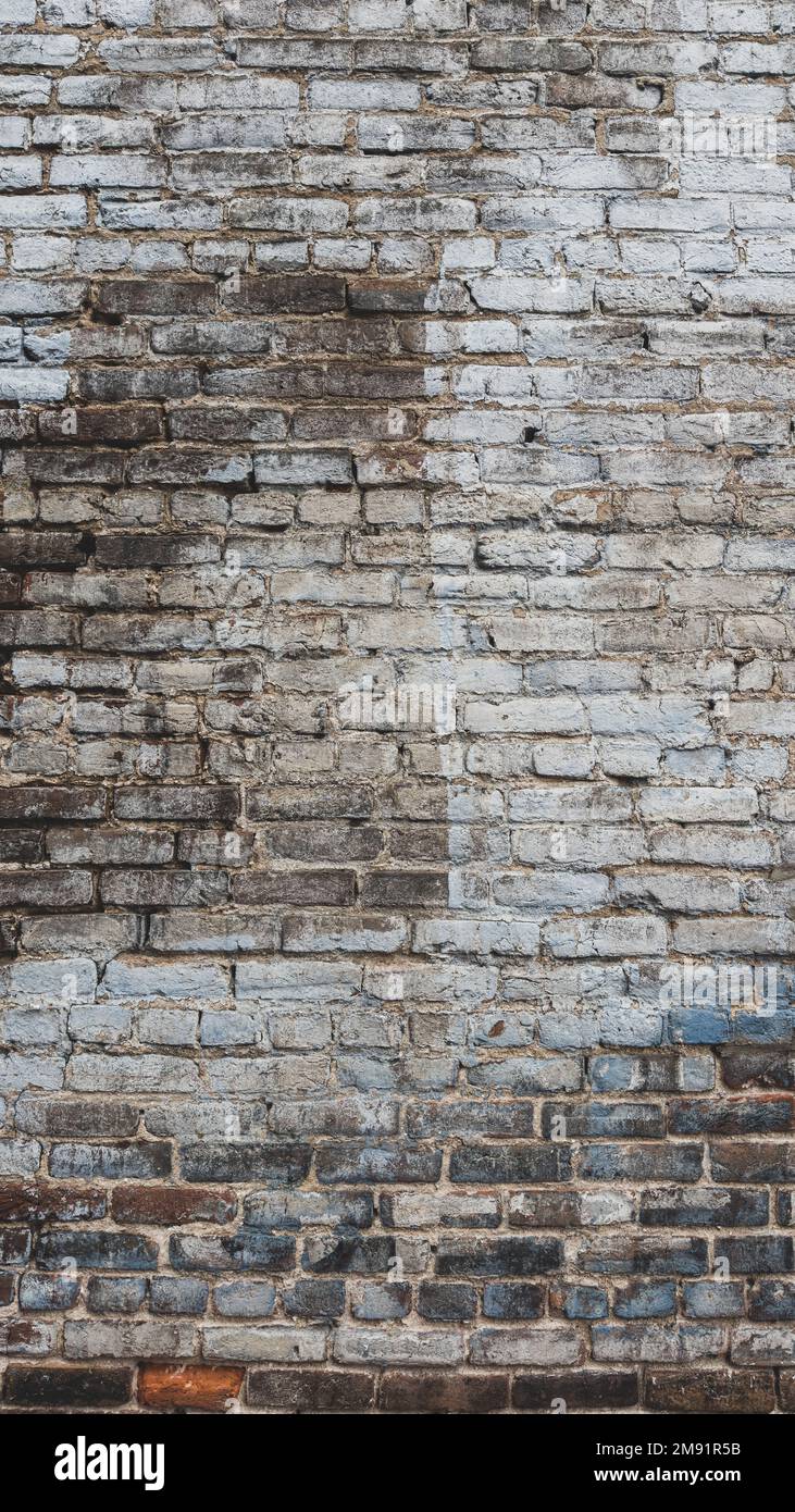 A vertical shot of a faded brick wall for backgrounds and overlays ...