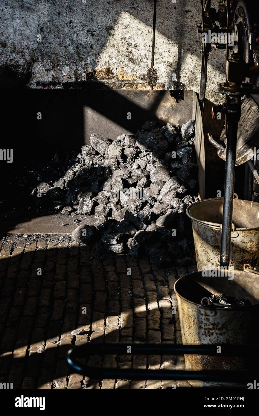 A pile of rocks in an old rusted container in industrial site Stock ...