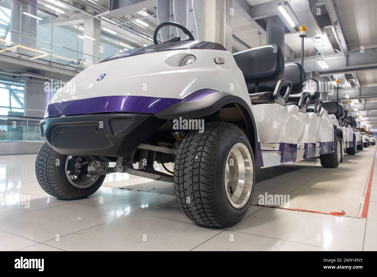 A convoy of electric cars parked in an airport terminal Stock Photo - Alamy