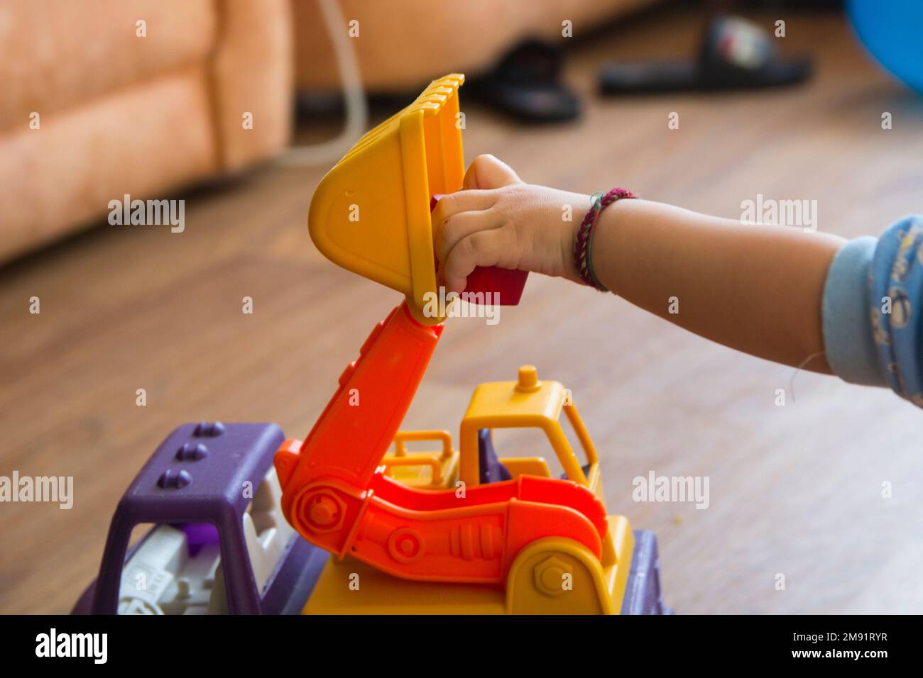 Kid's hand holding a toy car close-up Stock Photo - Alamy