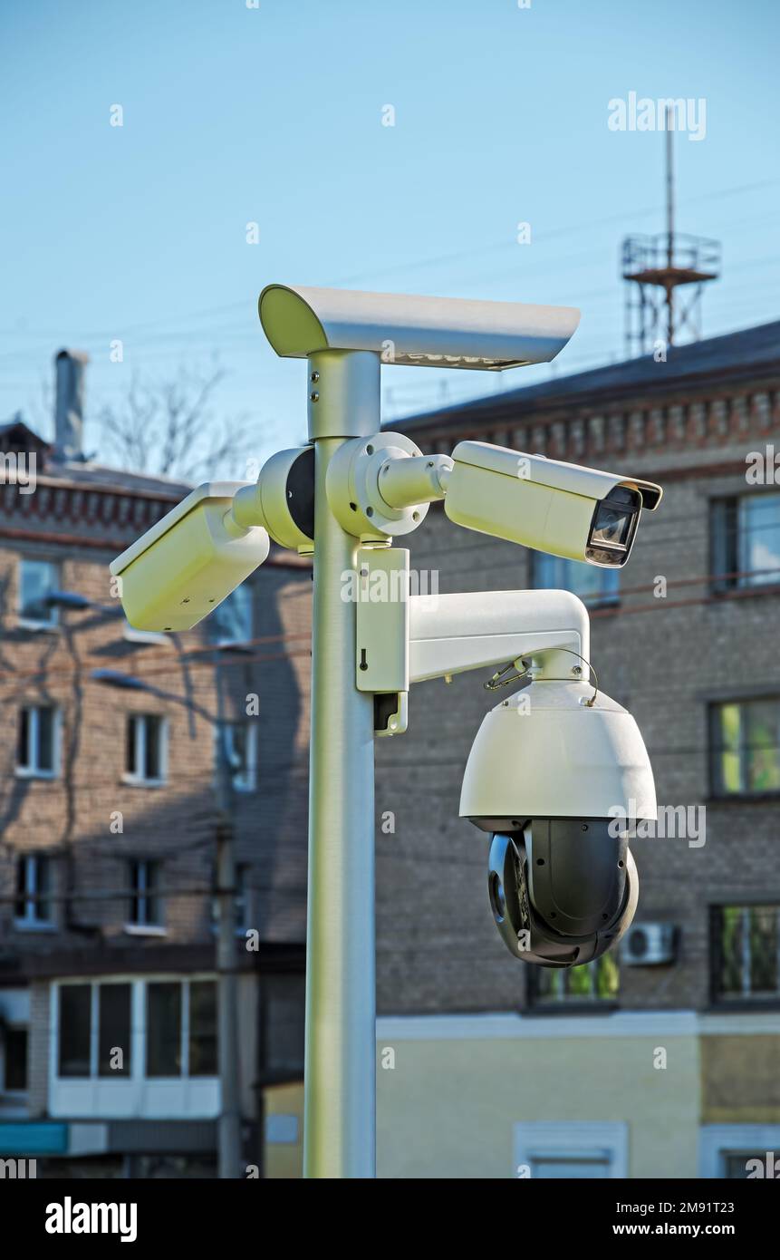 Three CCTV cameras and an LED lamp are installed on pole located on ...