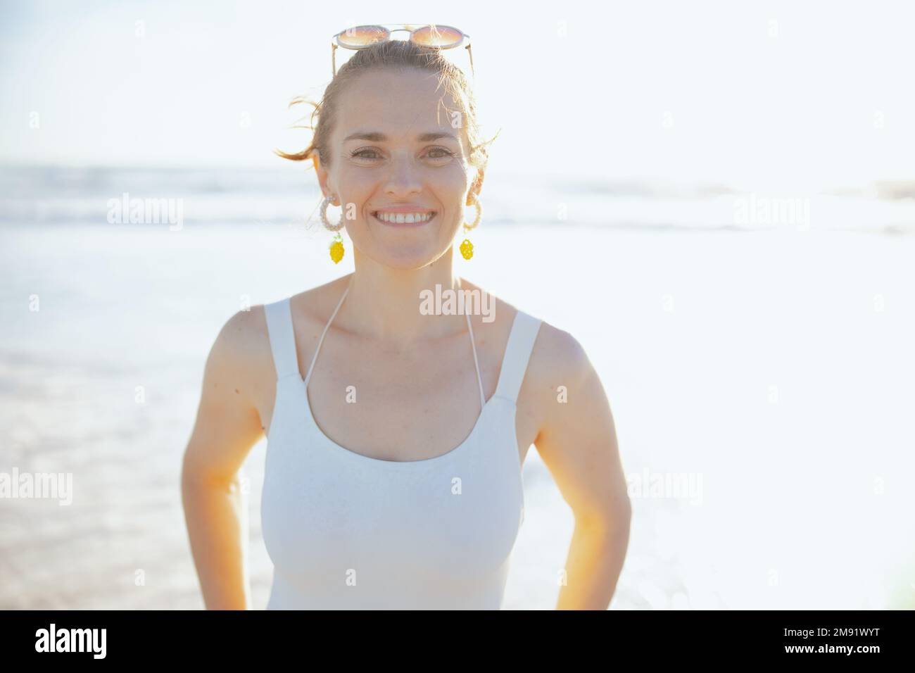 Portrait of happy elegant female in white swimsuit at the beach Stock ...