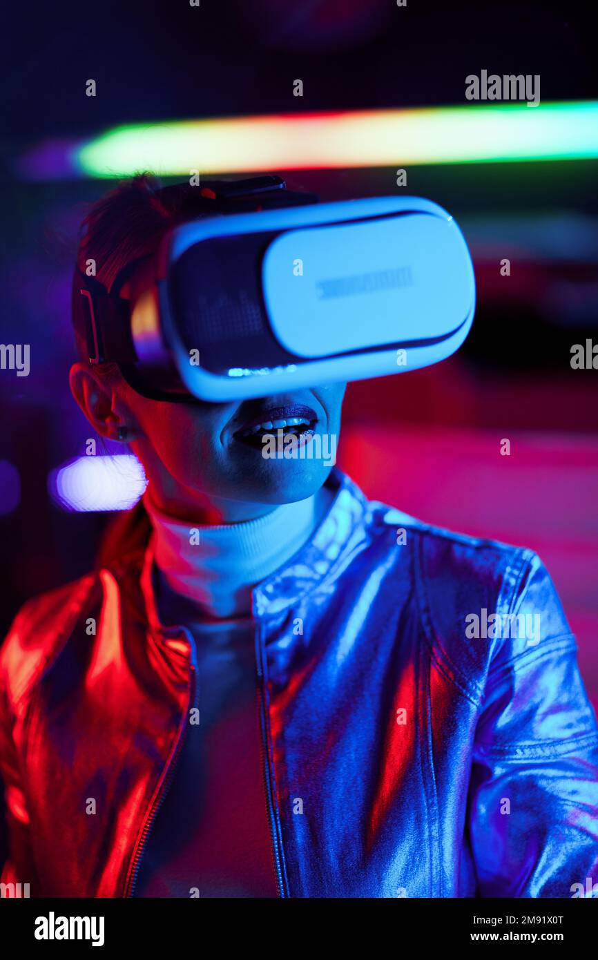 Neon metaverse futuristic concept. smiling stylish woman in vr headset ...