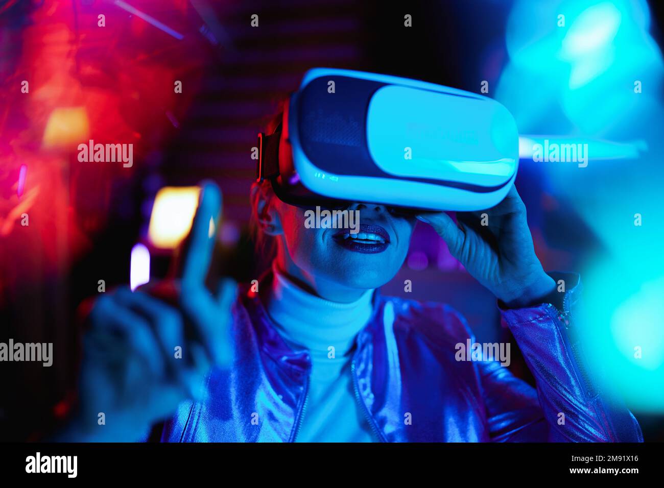 Neon metaverse futuristic concept. smiling modern female in vr headset ...
