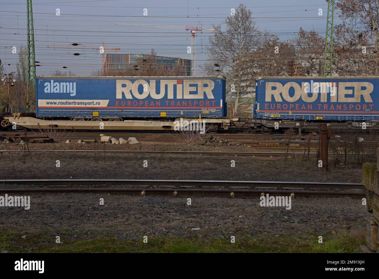 Articulated lorry trailers carried with shipping containers on a ...