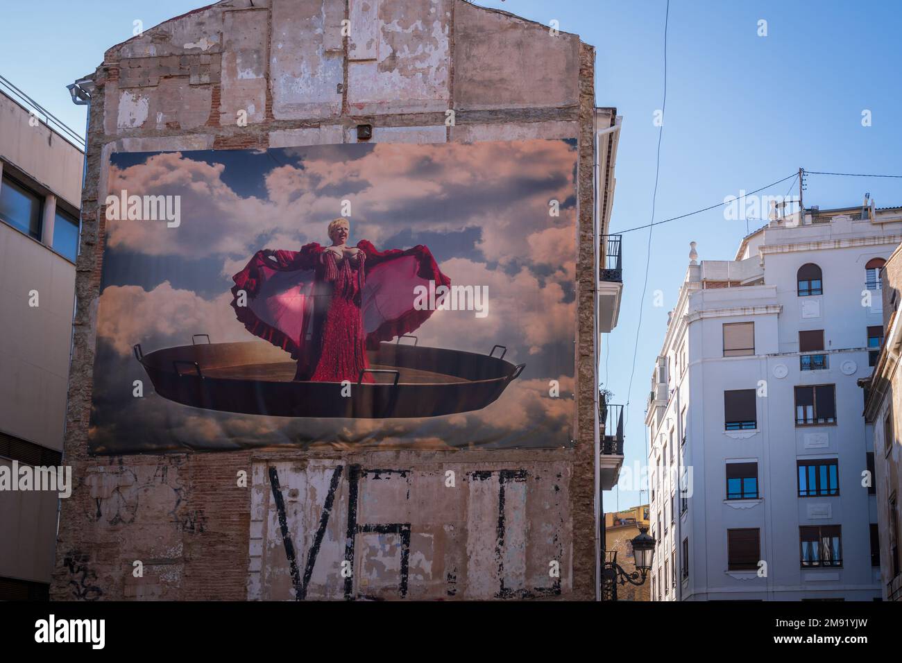 Graffiti on the wall in the historic district of Valencia. A woman ...