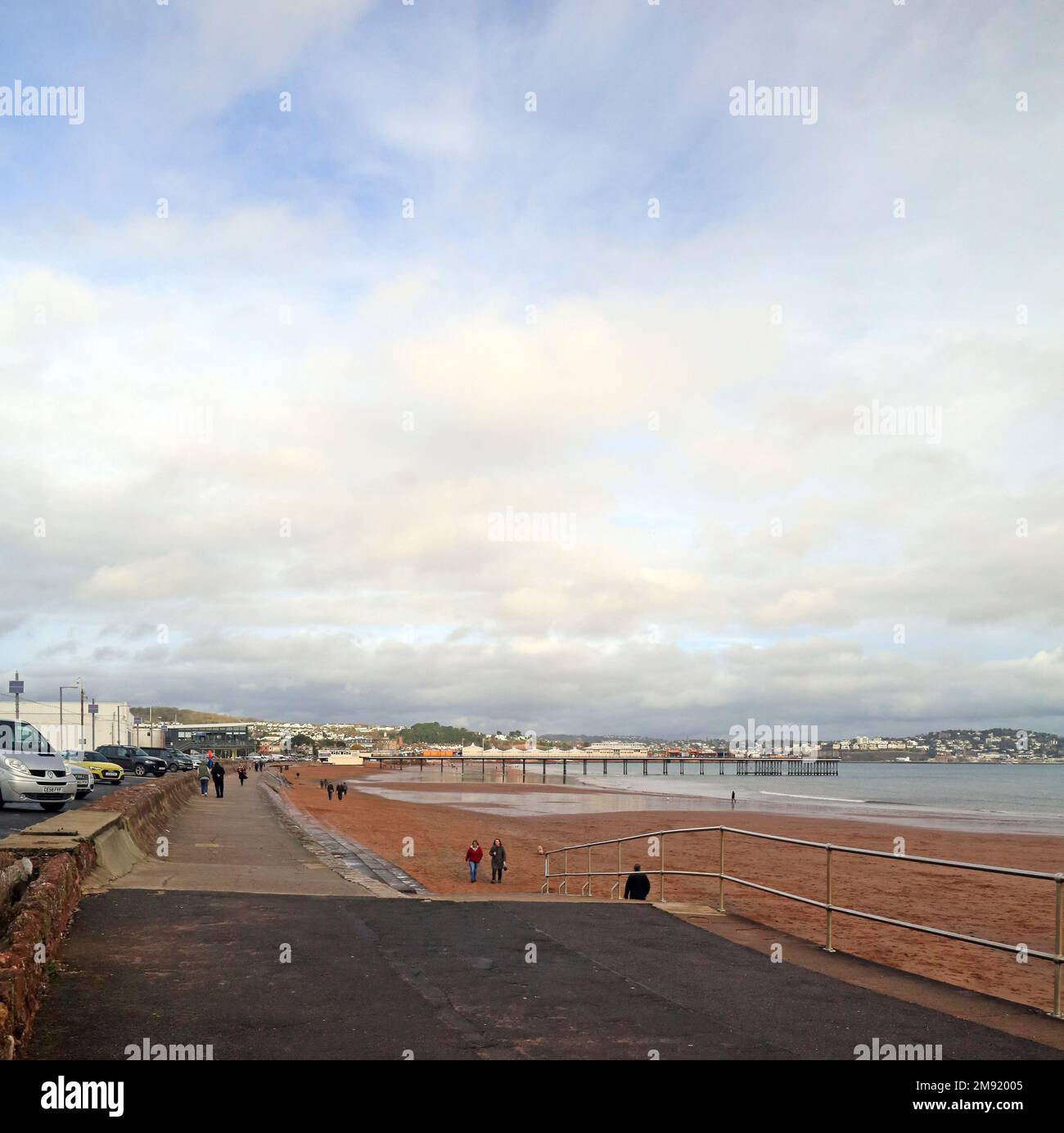 People enjoying winter sunshine at Paignton seafront and promenade with ...