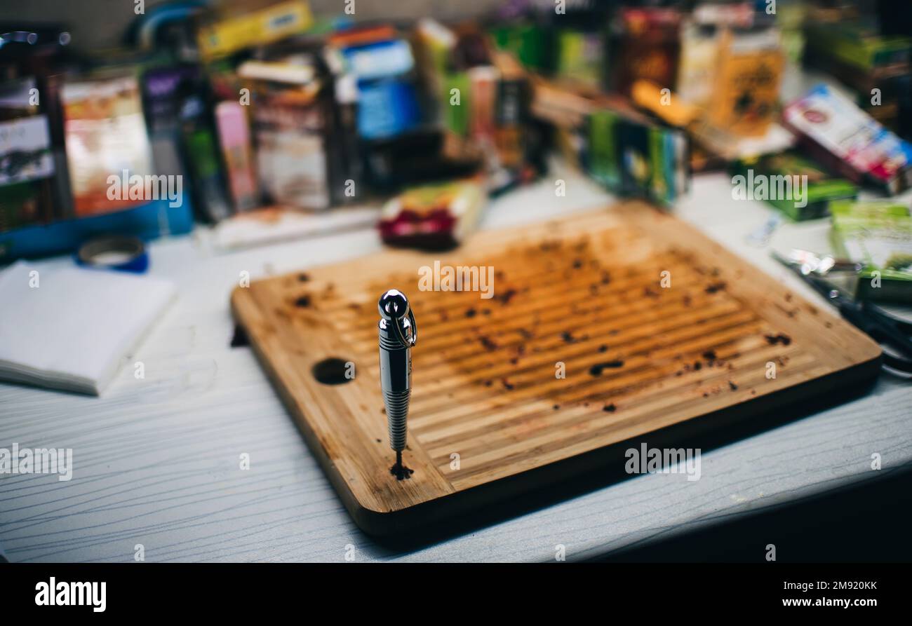 awl for piercing the foil for hookah on the table on blurred background ...