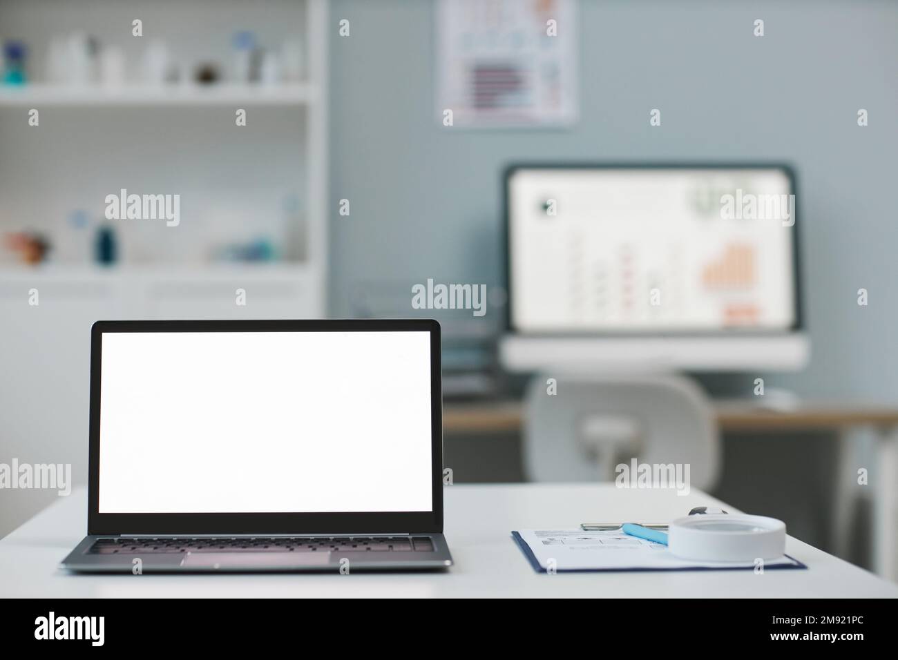 Laptop with blank white screen standing on workplace of modern ...