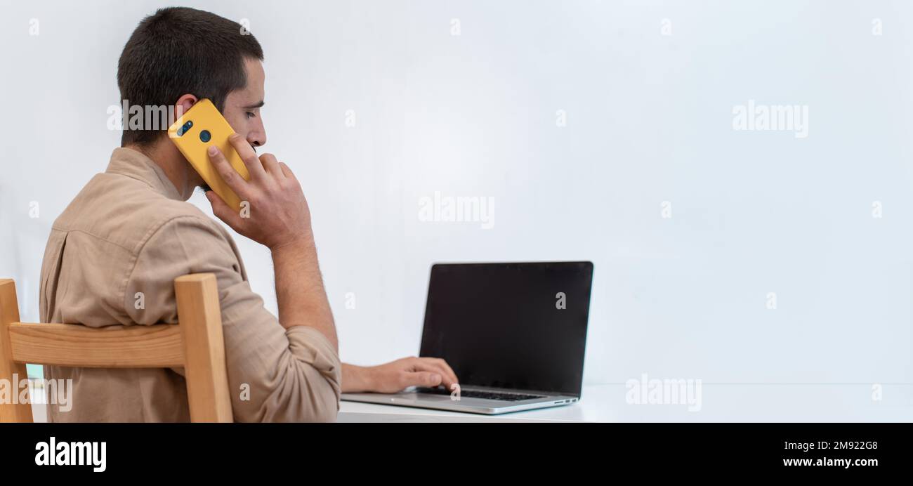 Young graphic designer sitting at his work desk and using a color ... Young graphic designer sitting at his work desk and using a color ...