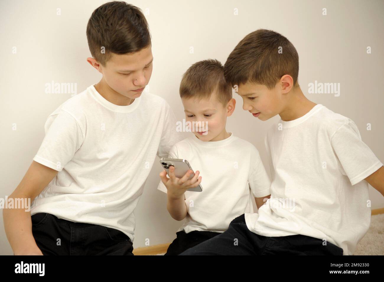 children of different ages look at phone with interest social networks ...
