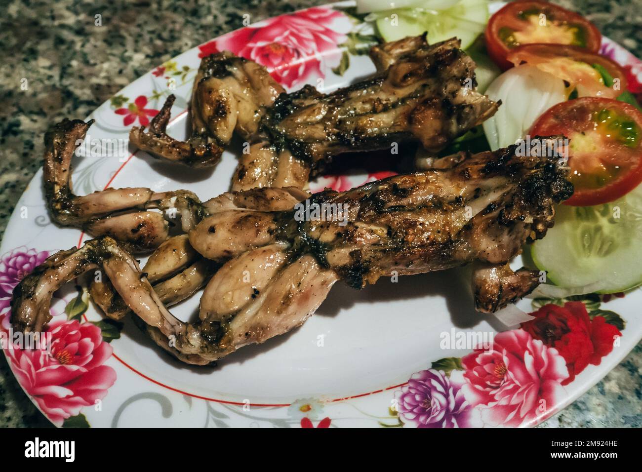 fried frogs on a plate for traditional French food Stock Photo - Alamy