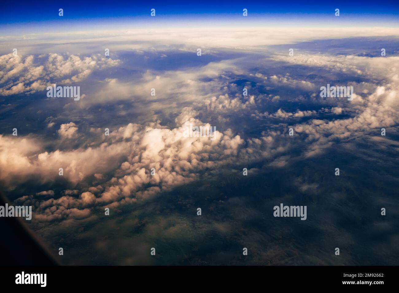 view from the window of the aircraft on the clouds and the ground from ...