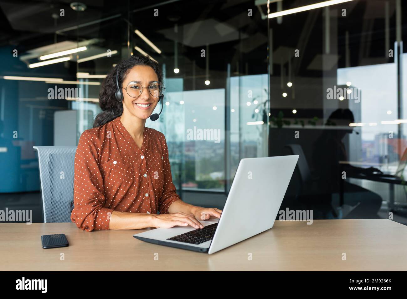 Portrait of Latin American business woman, office worker looking at ...