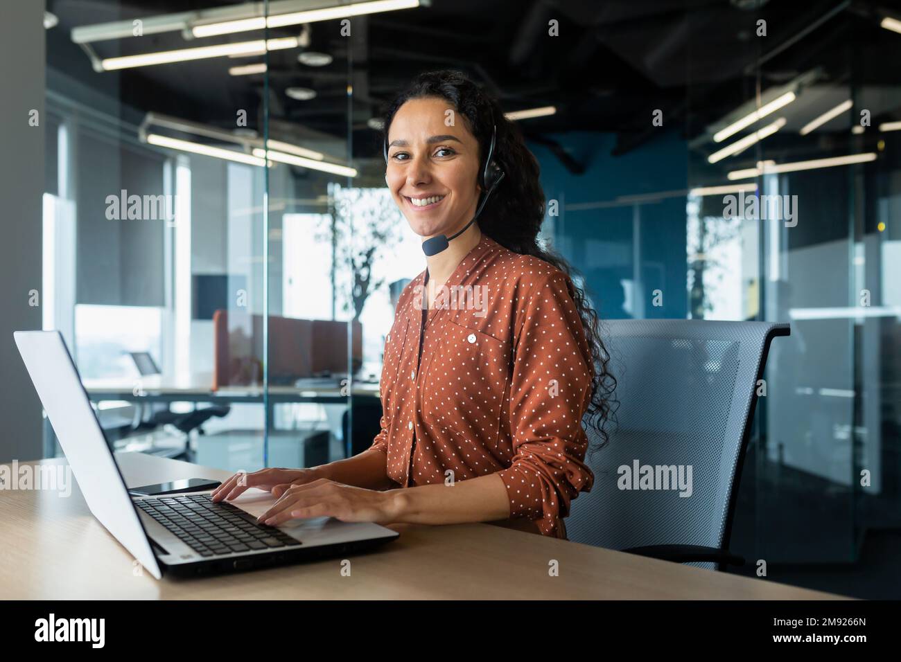 Portrait of Latin American business woman, office worker looking at ...
