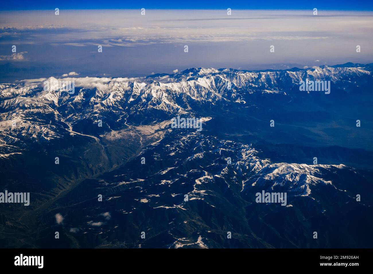 mountains with snowy peaks and sky with blue clouds from the ...