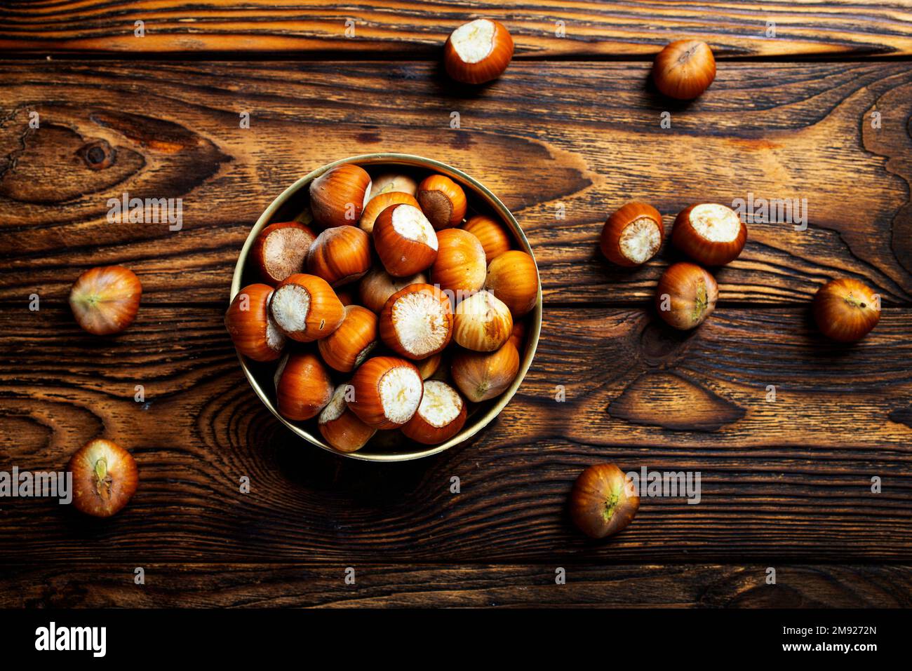 Hazelnuts on wooden backdrop. heap or stack of hazelnuts. Hazelnut ...
