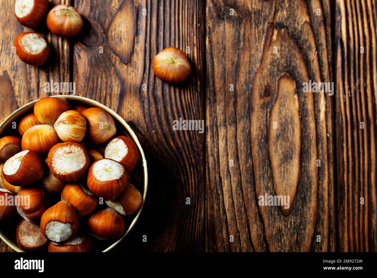 Hazelnuts on wooden backdrop. heap or stack of hazelnuts. Hazelnut ...