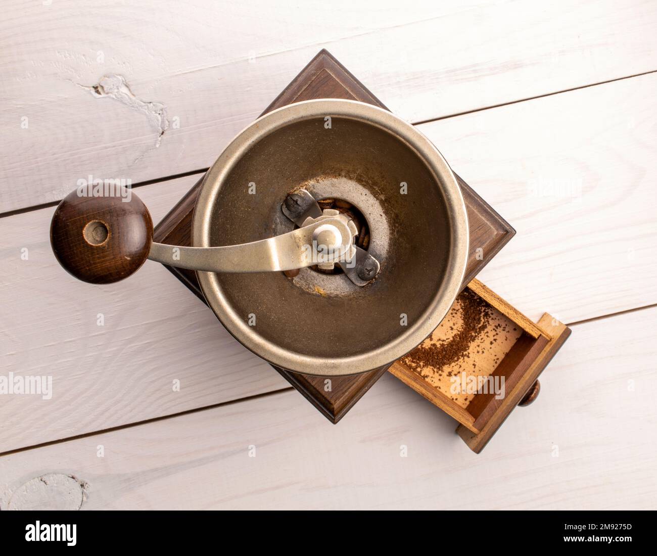 Manual coffee grinder on a white painted wooden table, top view Stock ...