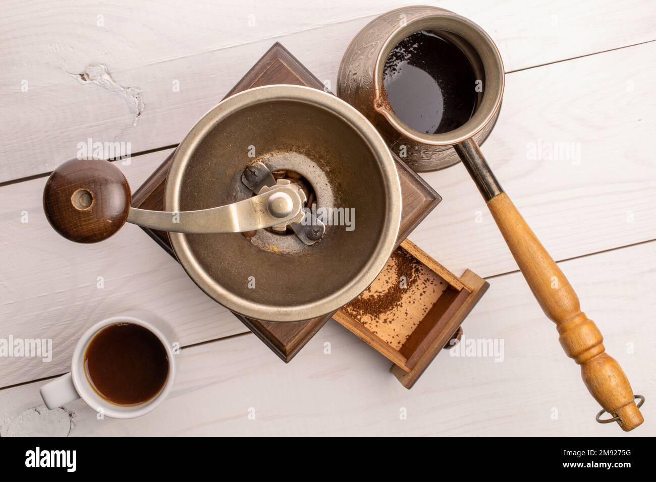 Manual coffee grinder on a white painted wooden table, top view Stock ...