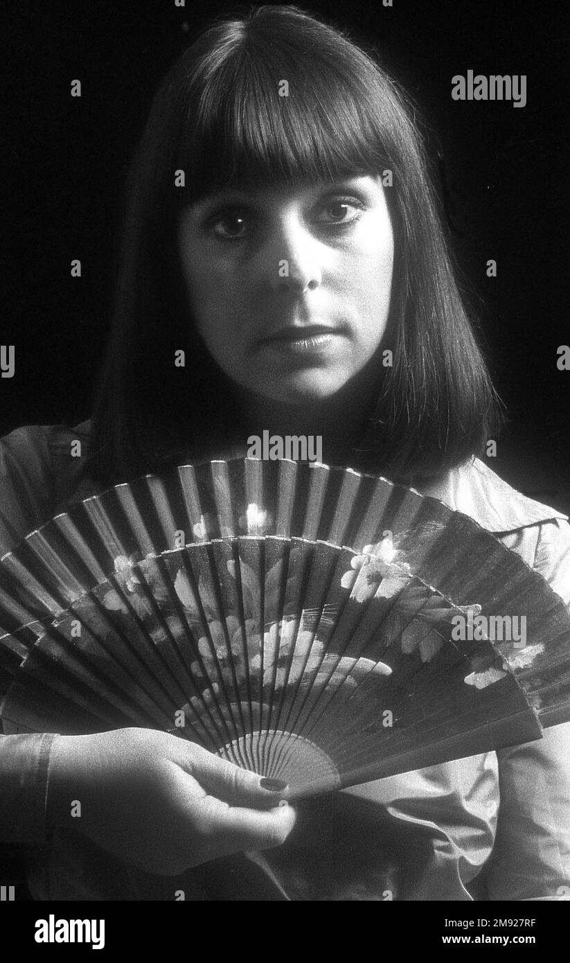 Young woman with a fan Stock Photo - Alamy