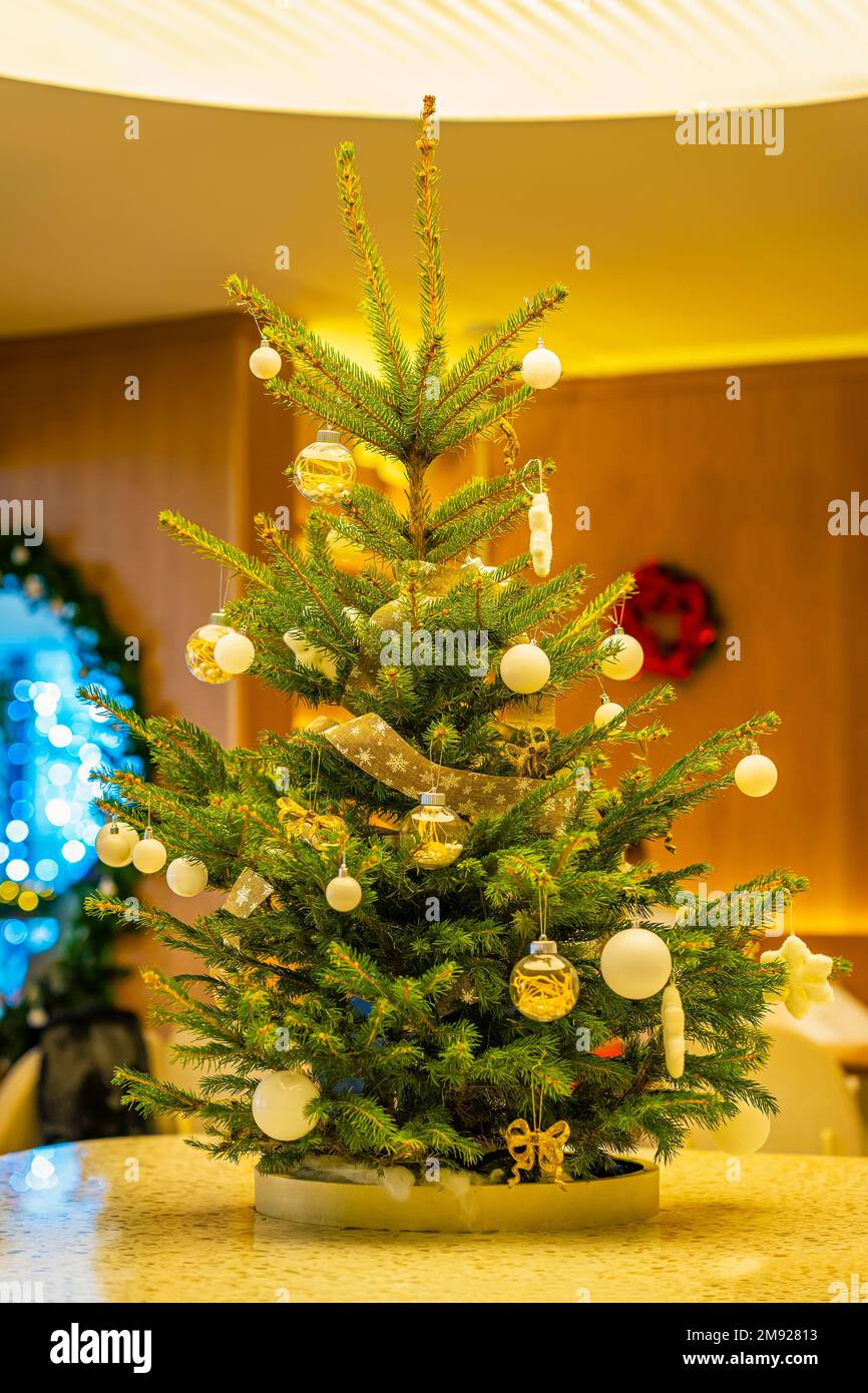 Christmas decorated tree in modern interior of living room, holiday ...
