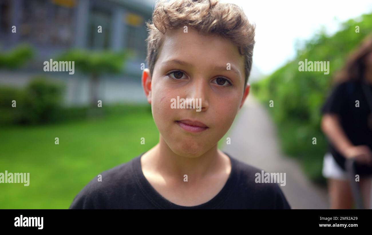 Child walking outside in slow-motion. Pensive thinking boy Stock Photo ...