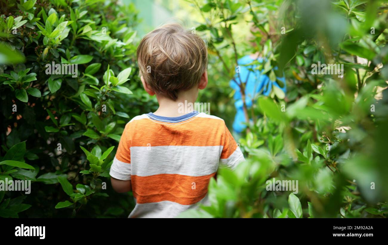 Child walking through garden meadows trail. Kid walks through green ...