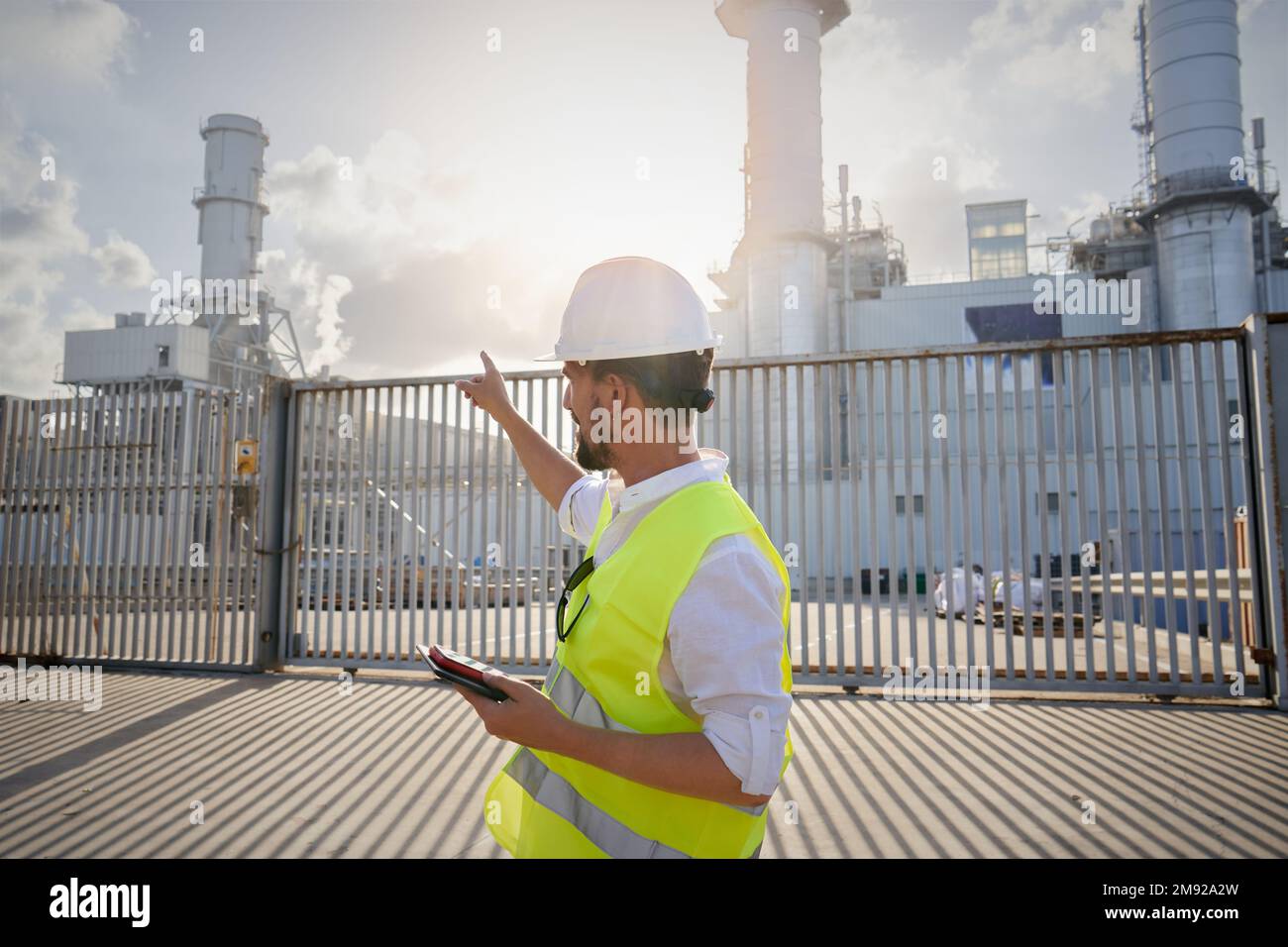 Caucasian male engineer worker standing outside industrial factory ...