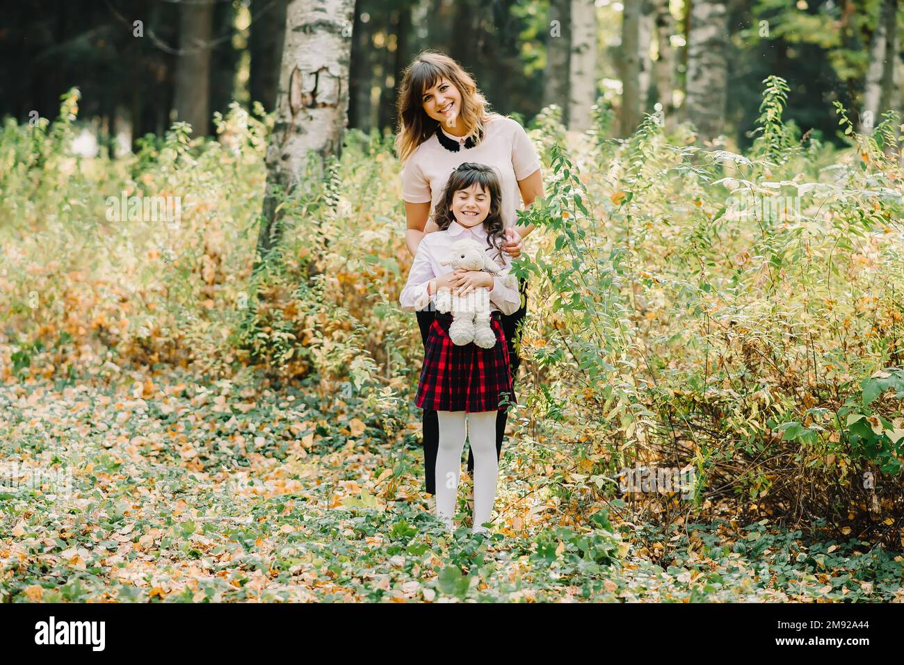happy family of mom and daughter hugging and laughing in the fall in the Park Stock Photo - Alamy