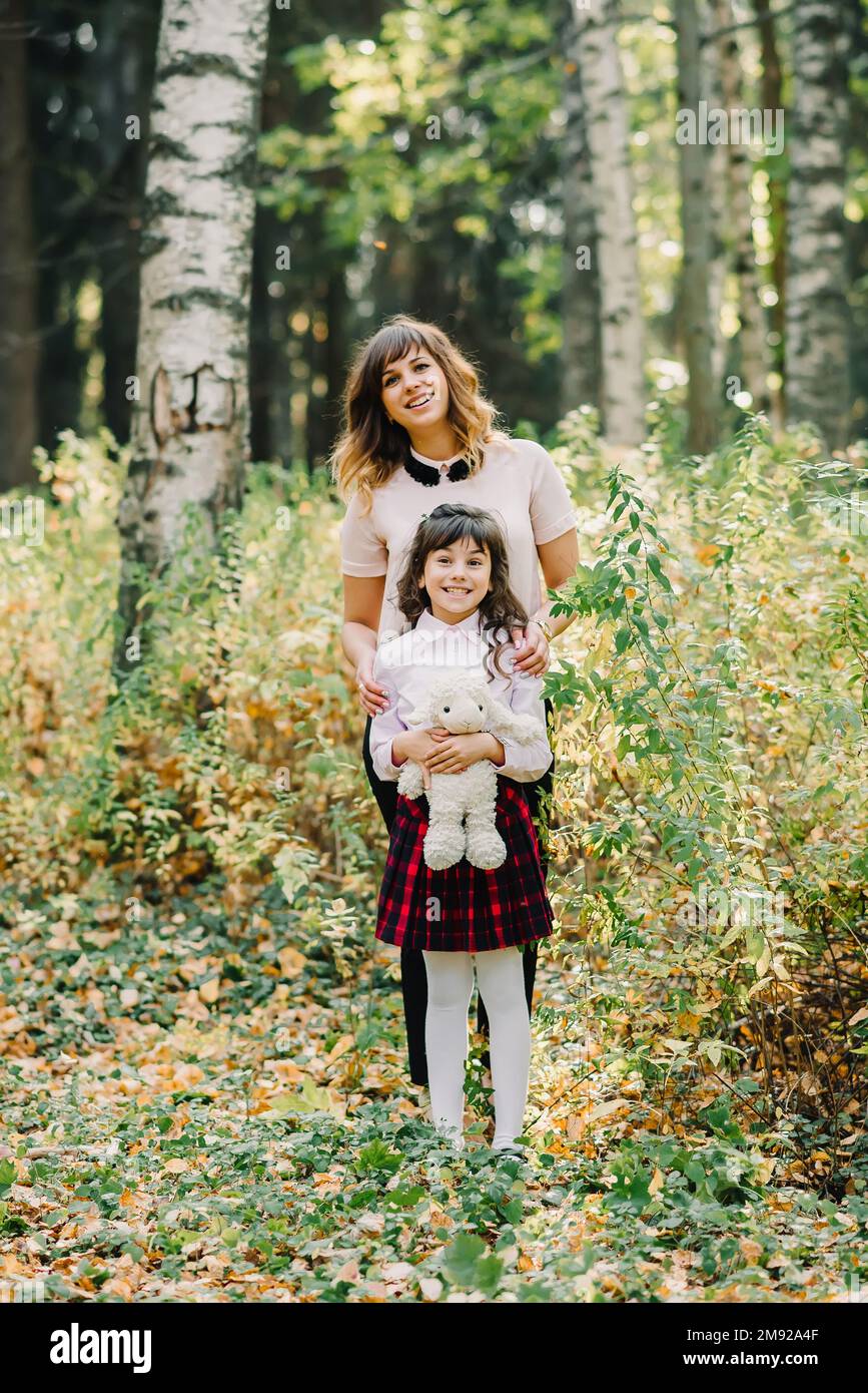 happy family of mom and daughter hugging and laughing in the fall in the Park Stock Photo - Alamy