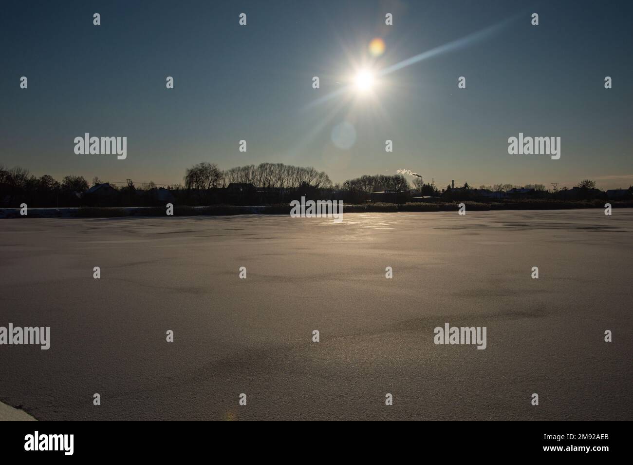 Winter landscape with the sun in contrast on a cold day, fields and ...