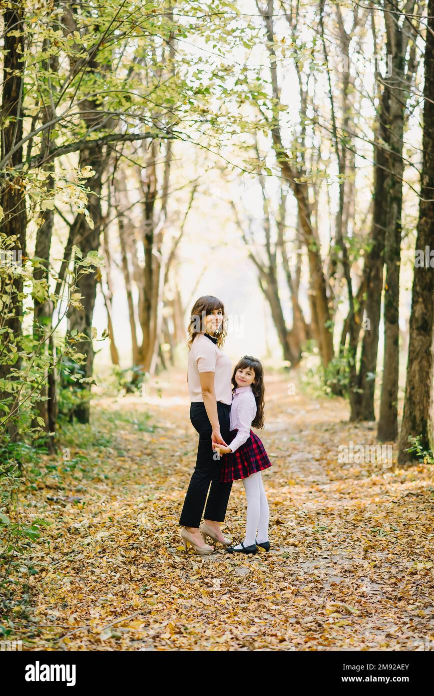 happy mom and daughter fall in the Park holding hands and smiling Stock ...