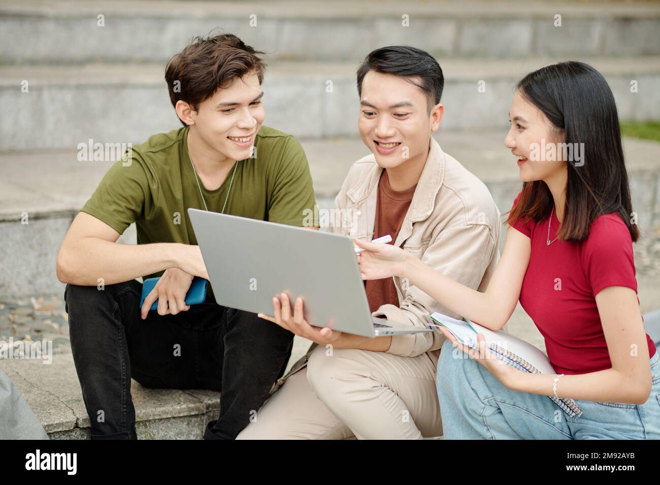 Group of happy students discussing presentation they created for class ...