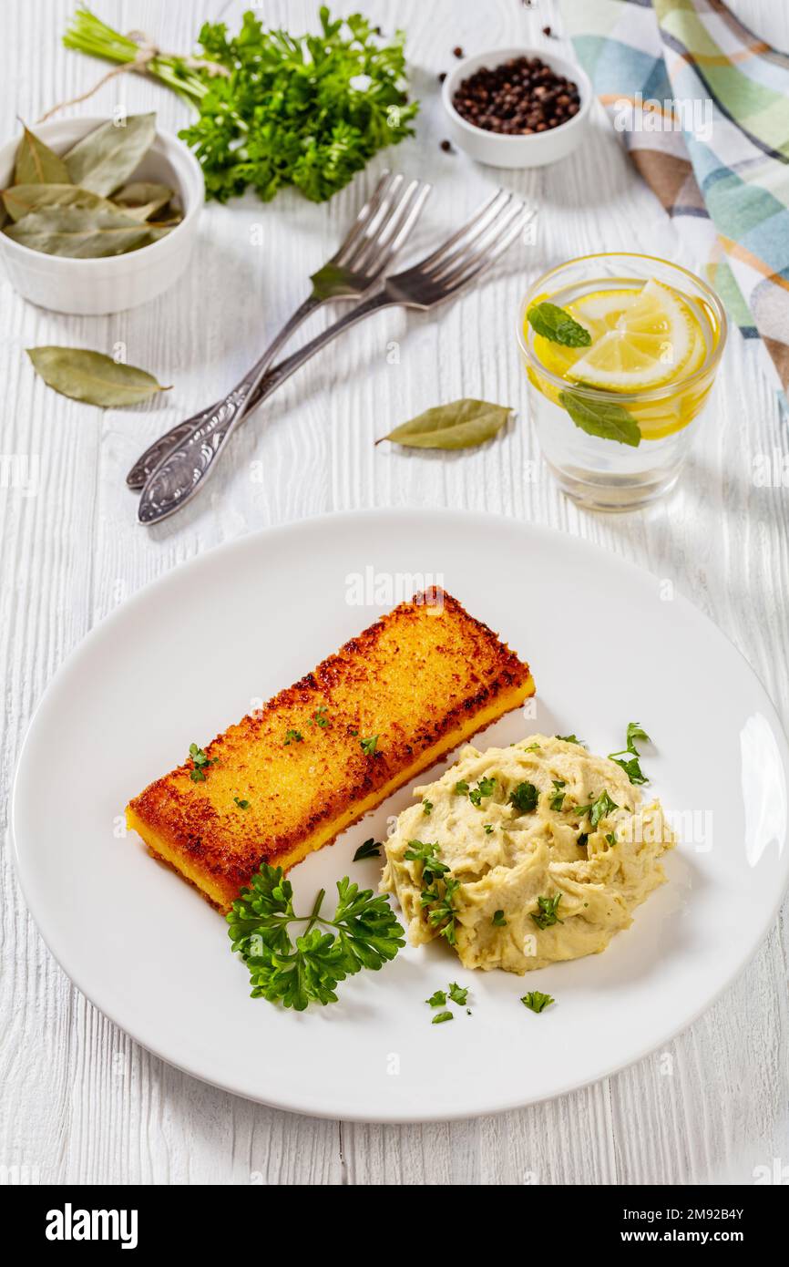 Baccala mantecato, creamed salt cod with toasted polenta on white plate ...