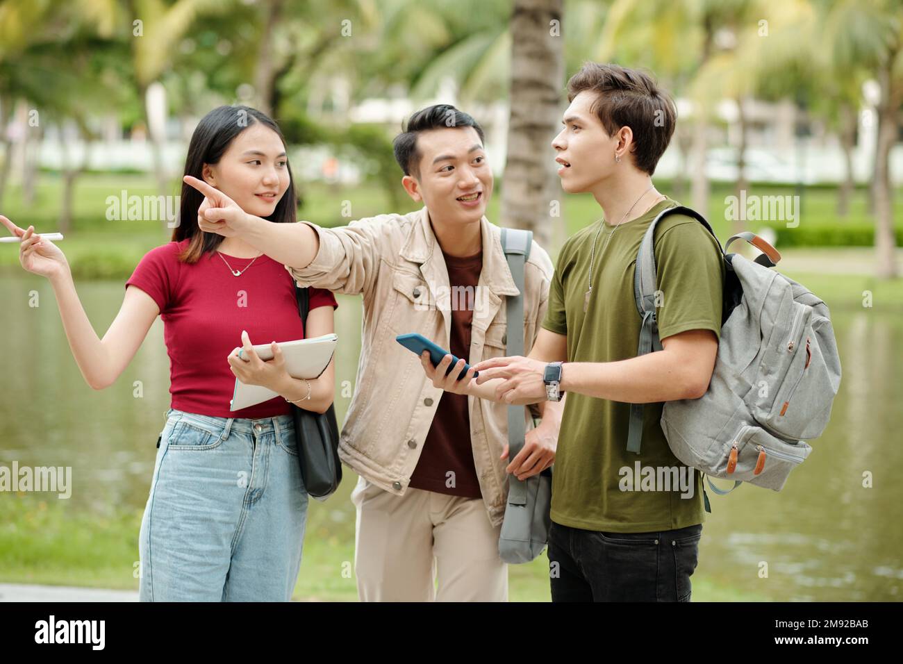 Students helping freshman to find dormitory on campus territory Stock ...
