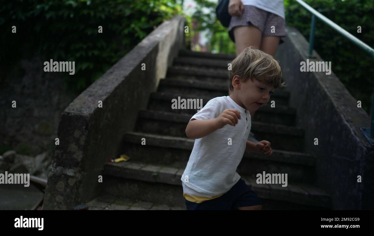 Child going down the stairs. toddler boy stepping down stairs Stock ...